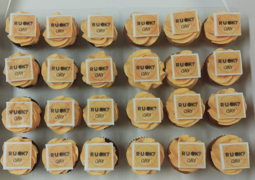 R U OK? day mini yellow cupcakes with an edible logo
